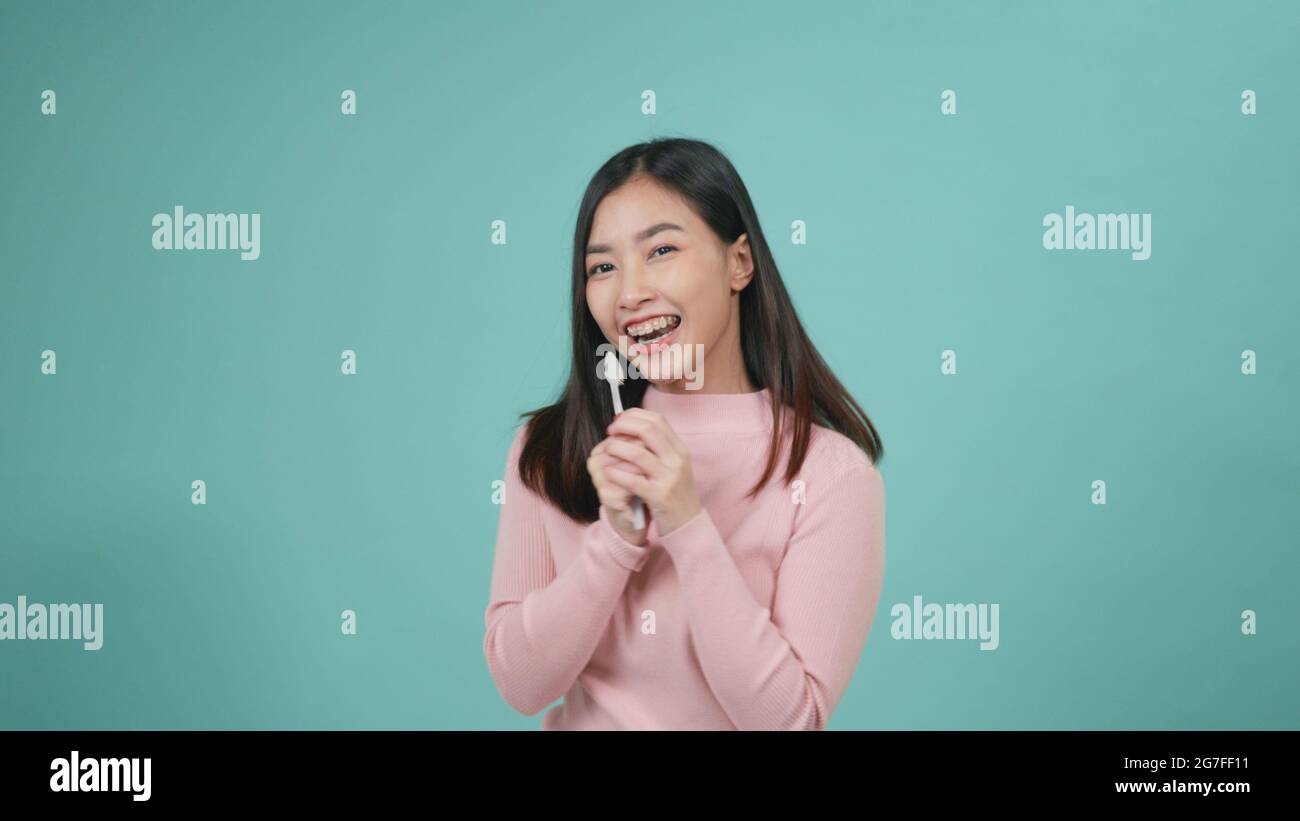 Asian young beautiful woman smile brushing teeth dancing enjoying music ...