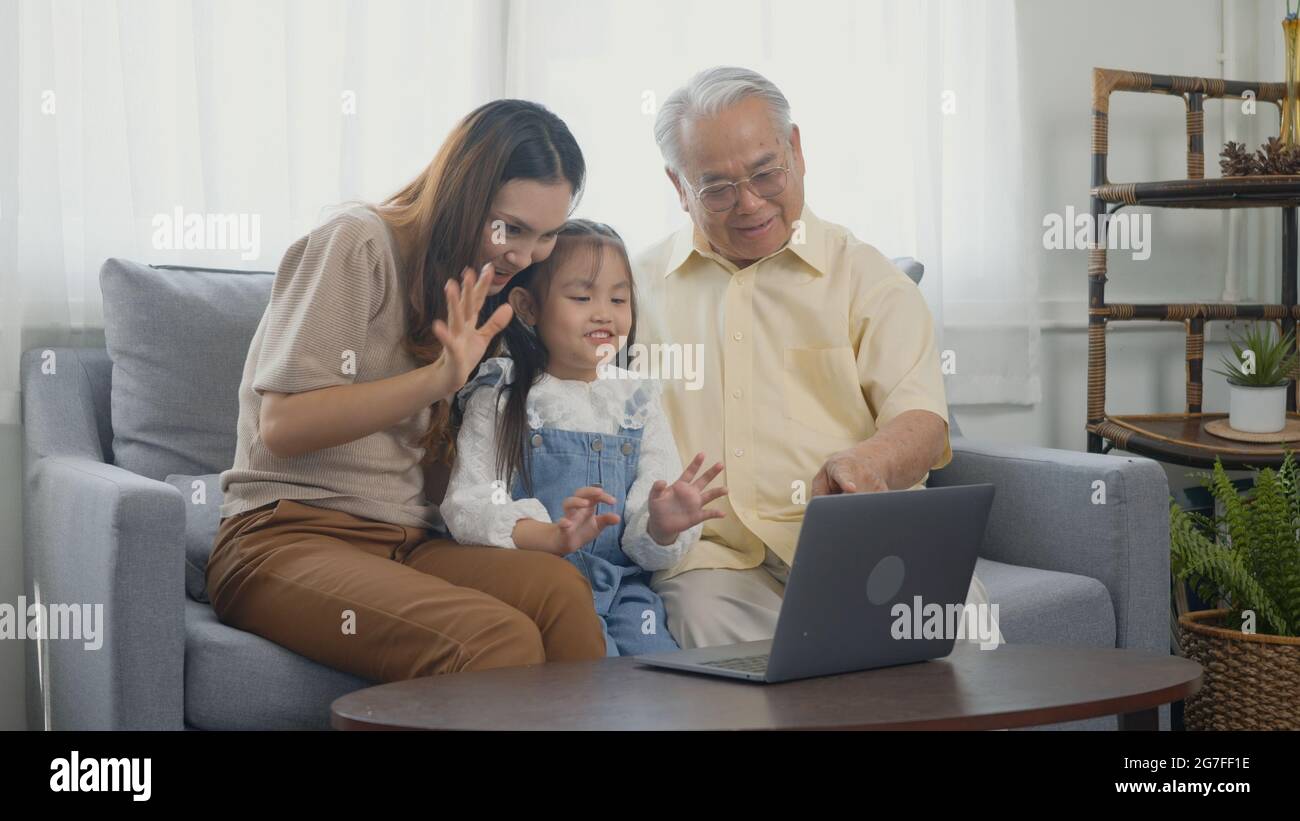 Happy family senior grandfather, daughter and granddaughter talking ...