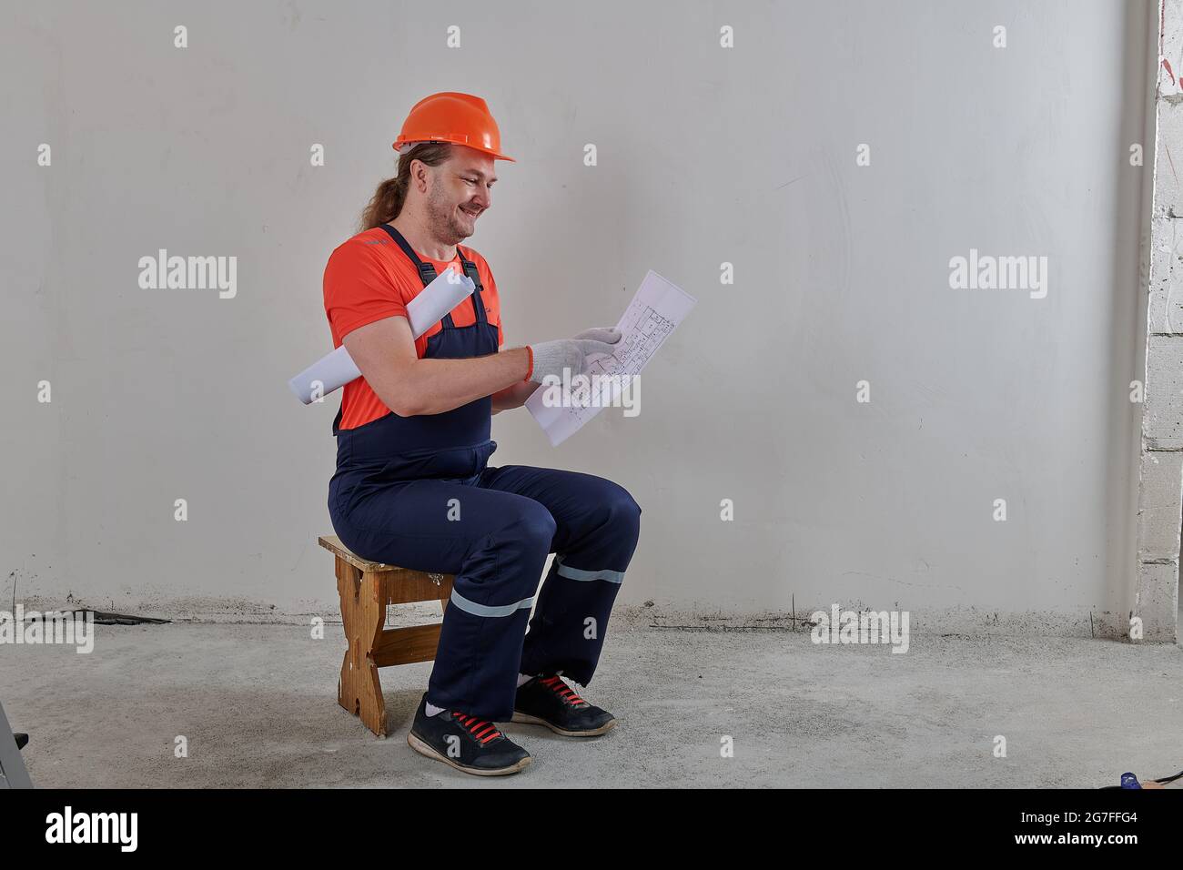 Construction engineer sits on concrete hi-res stock photography and ...