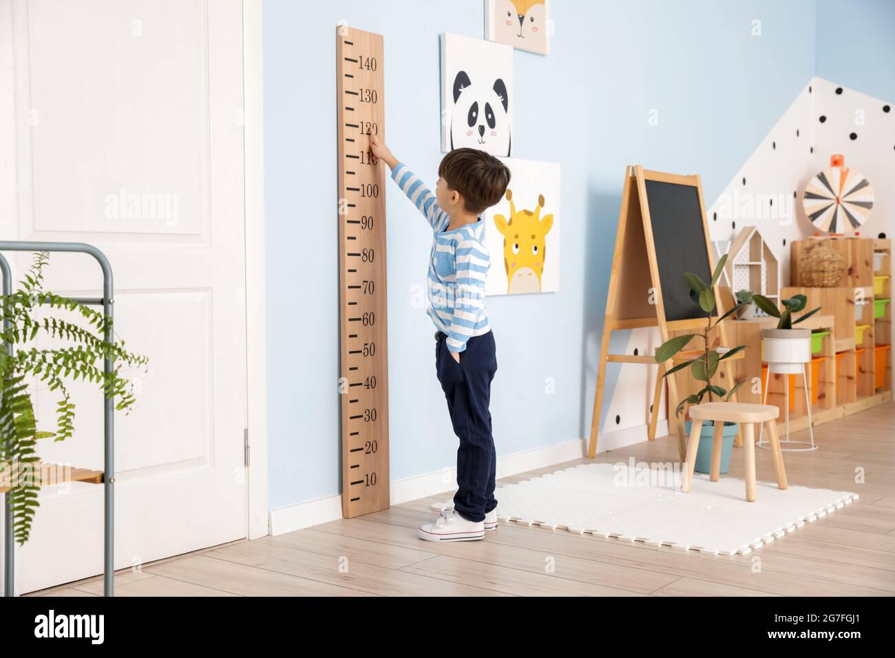 Little boy measuring height at home Stock Photo - Alamy