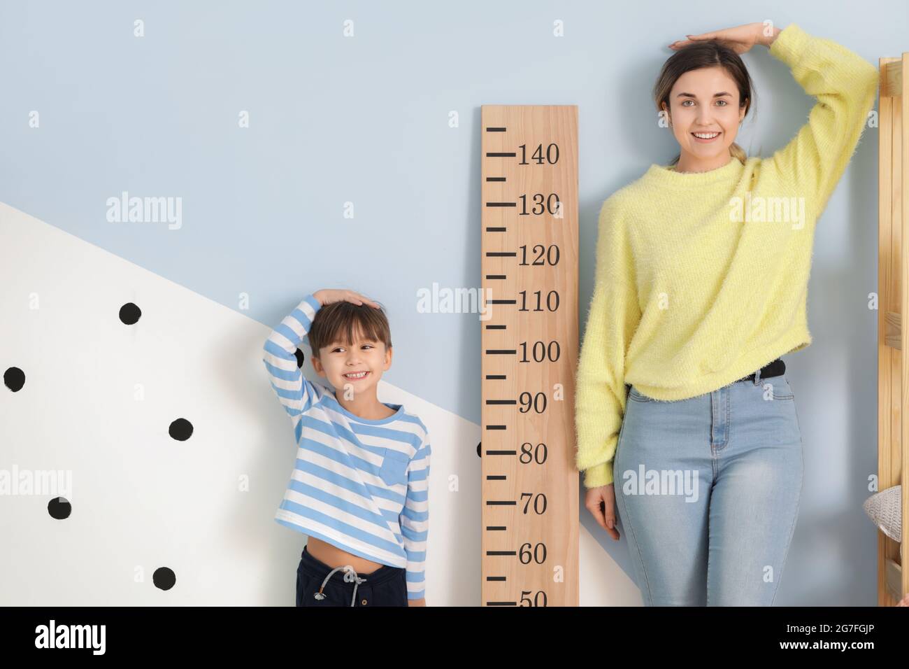 Little boy and his mother measuring height at home Stock Photo - Alamy