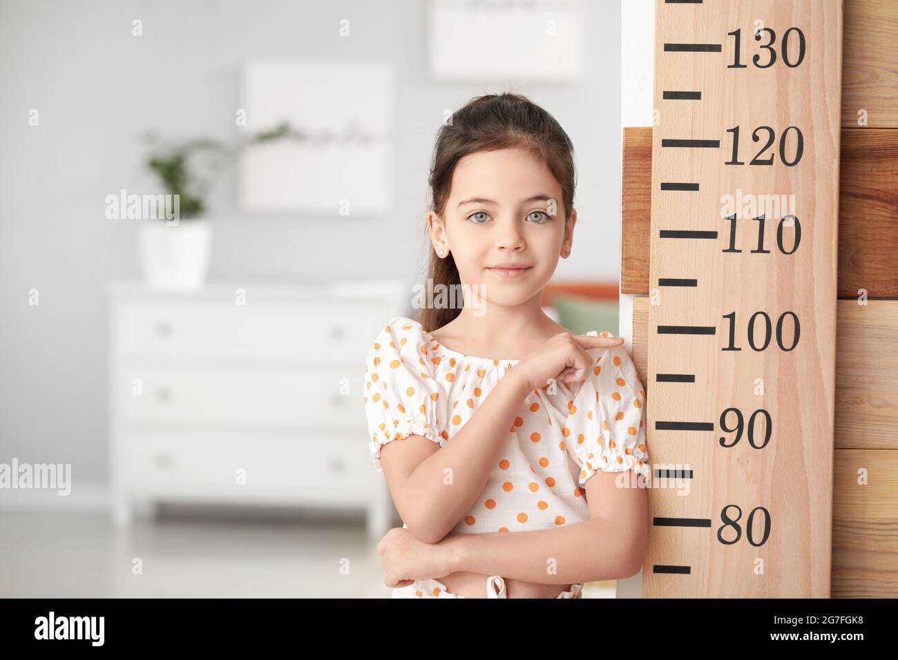 Little girl measuring height at home Stock Photo - Alamy