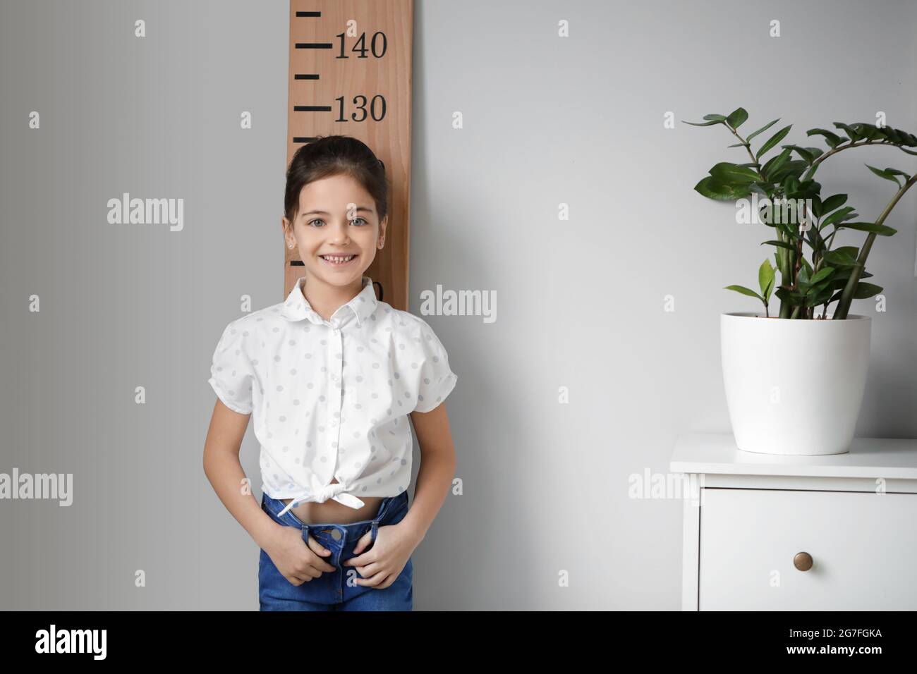 Little girl measuring height at home Stock Photo - Alamy