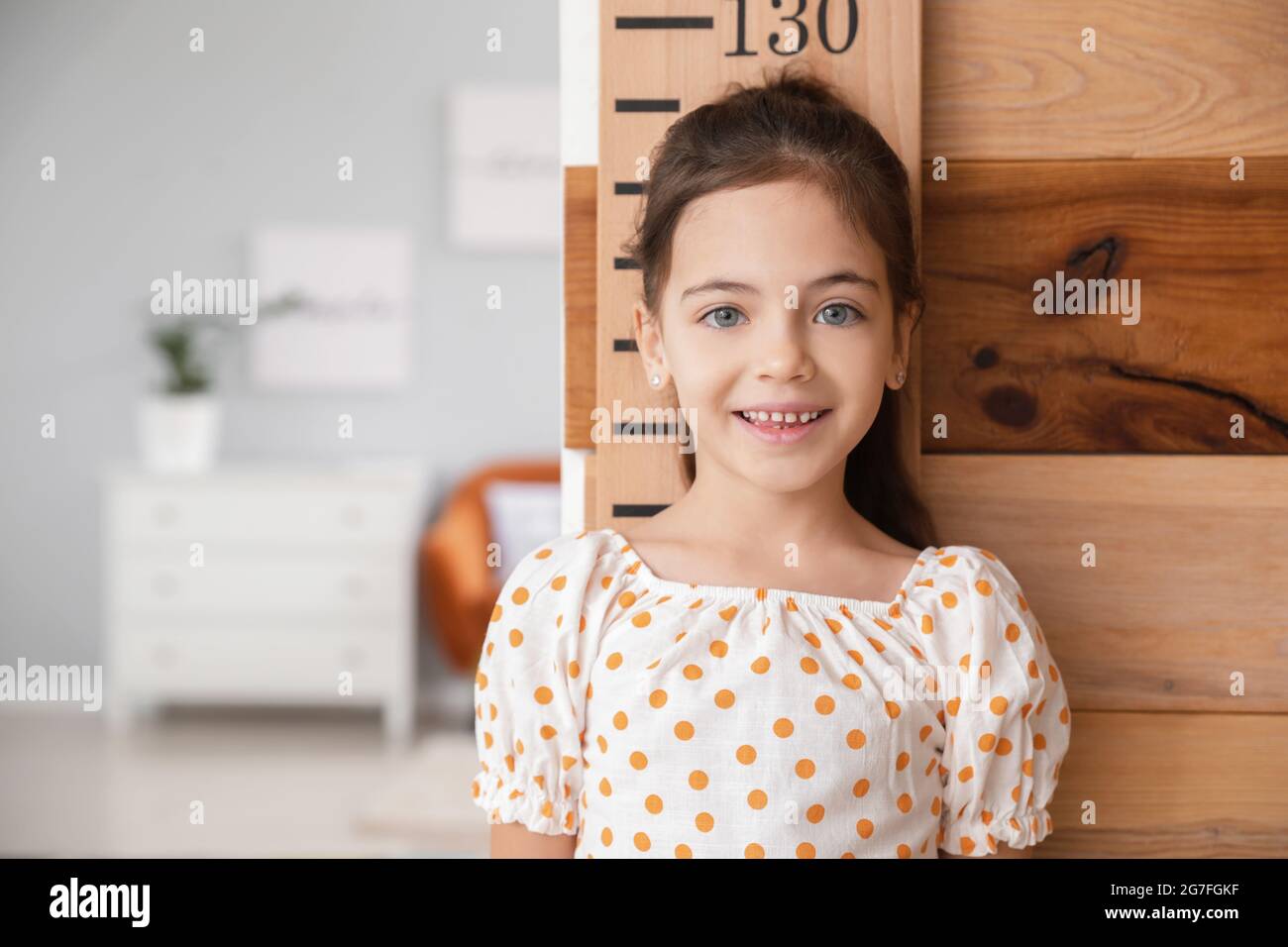 Little girl measuring height at home Stock Photo - Alamy