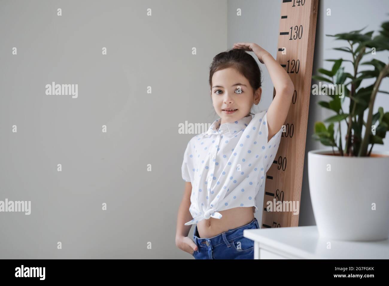 Little girl measuring height at home Stock Photo - Alamy