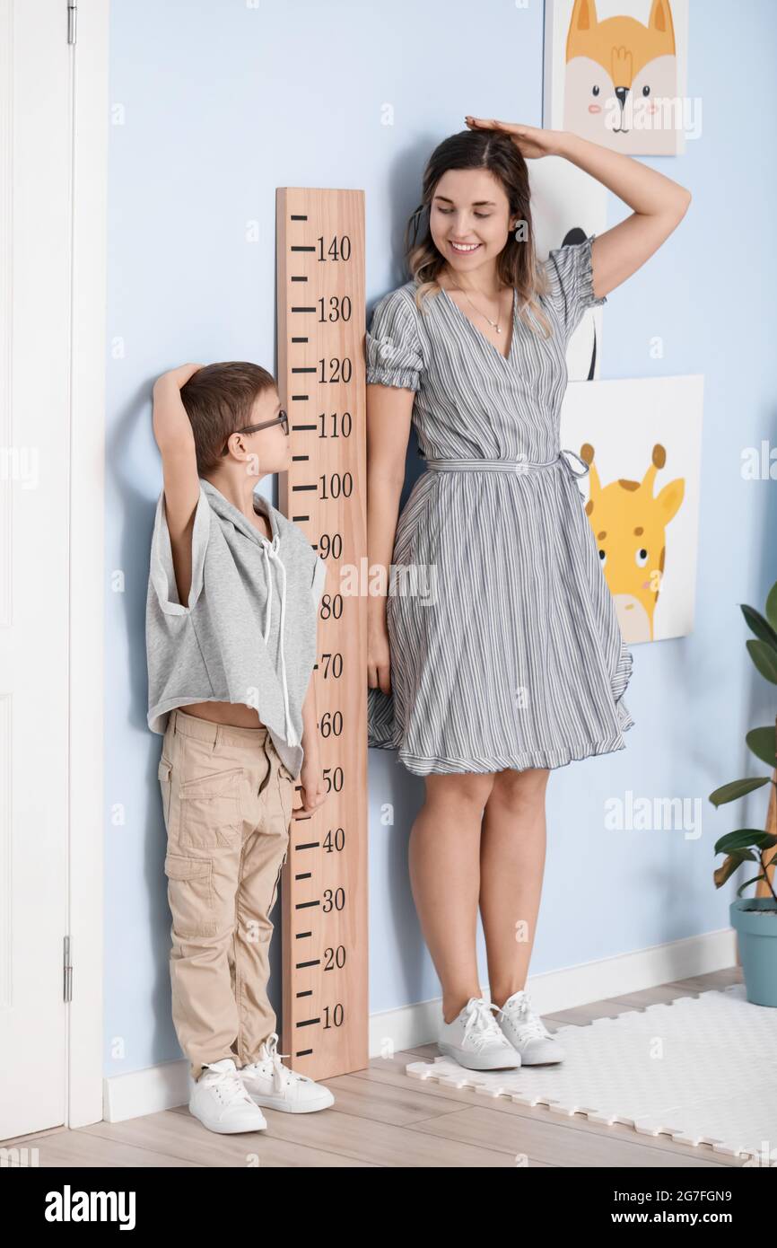 Little boy and his mother measuring height at home Stock Photo - Alamy