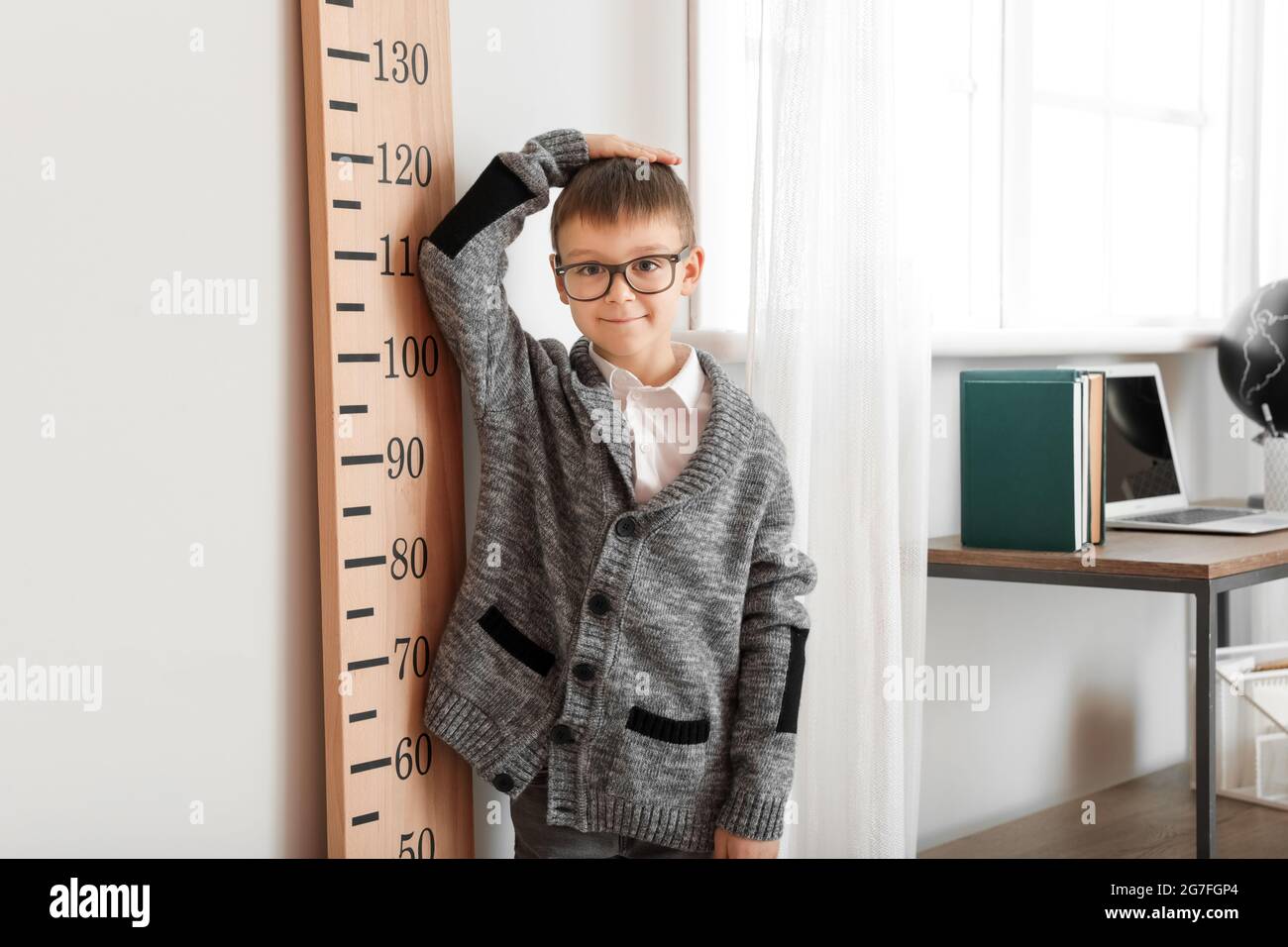 Little boy measuring height at home Stock Photo - Alamy