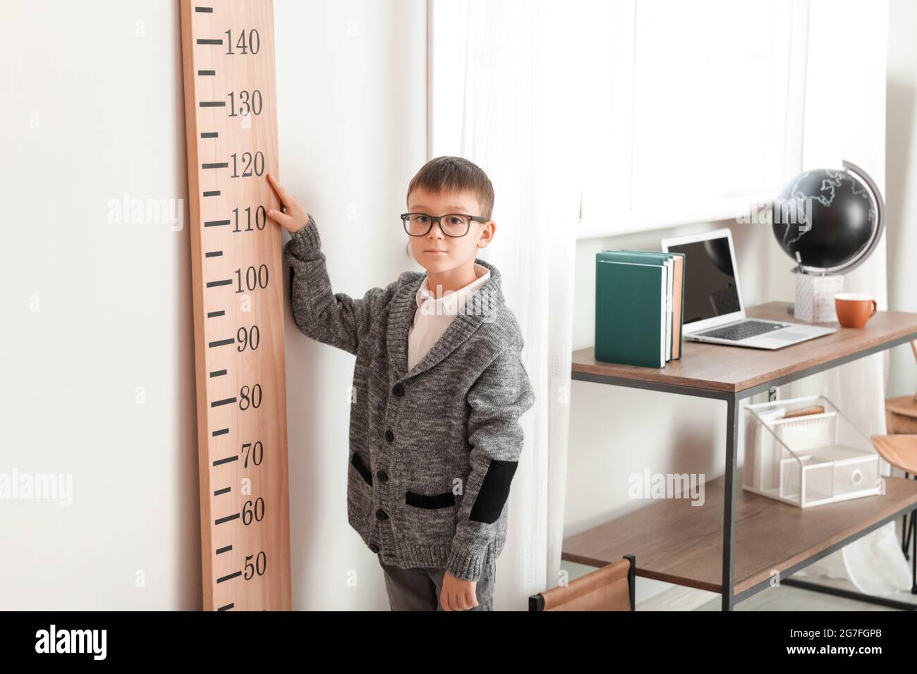 Little boy measuring height at home Stock Photo - Alamy