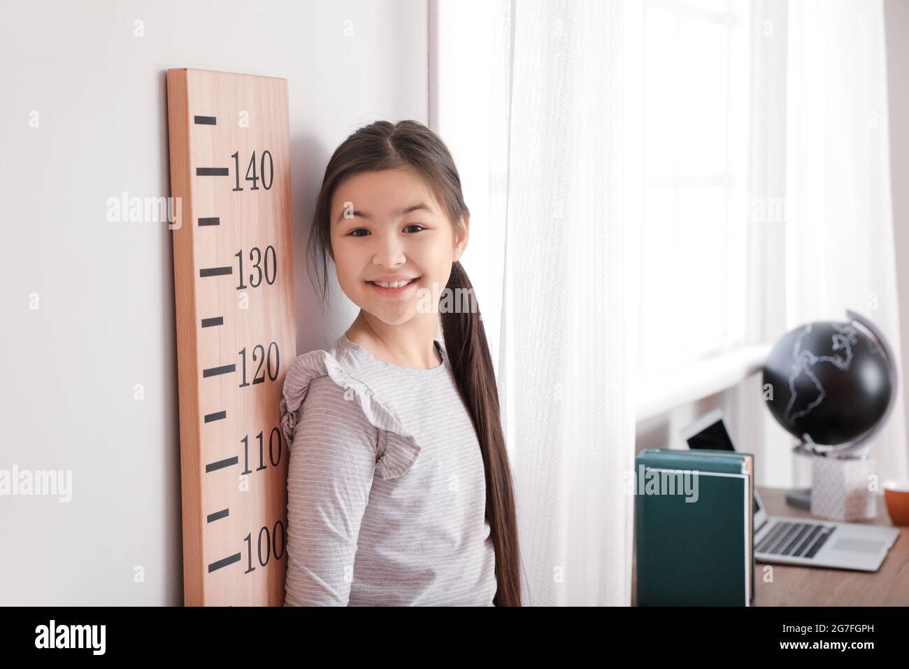 Little girl measuring height at home Stock Photo - Alamy