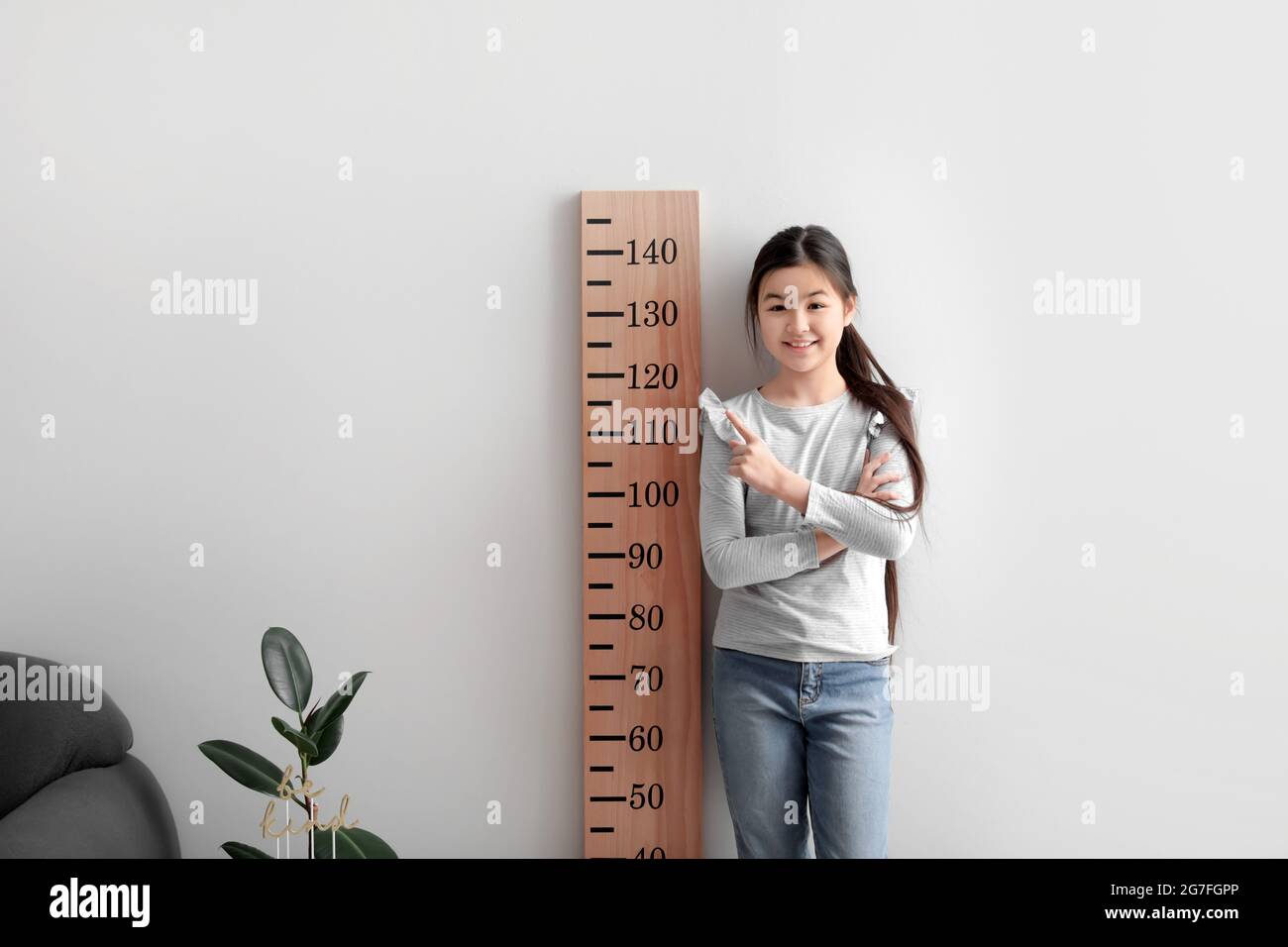 Little girl measuring height at home Stock Photo - Alamy
