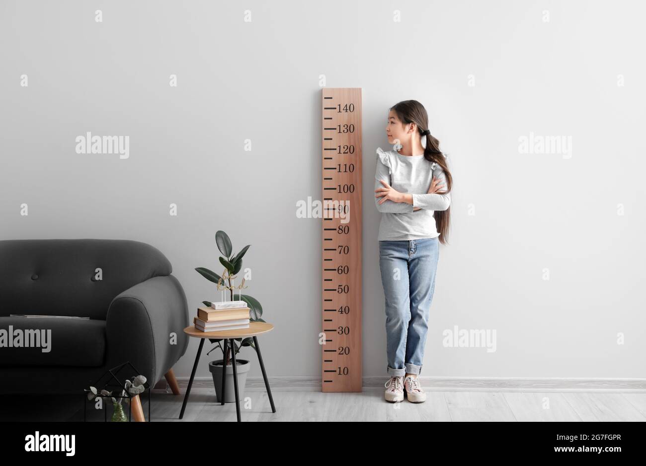 Little girl measuring height at home Stock Photo - Alamy