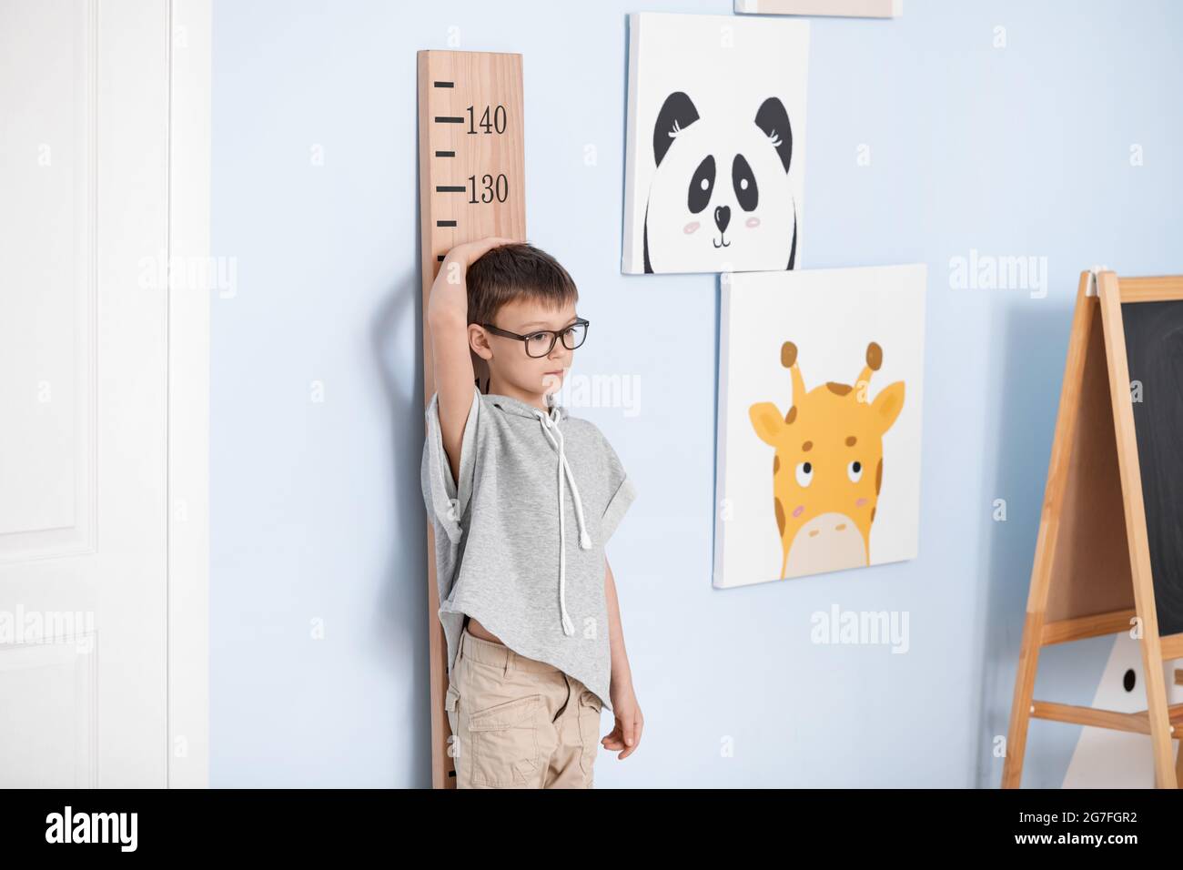 Little boy measuring height at home Stock Photo - Alamy