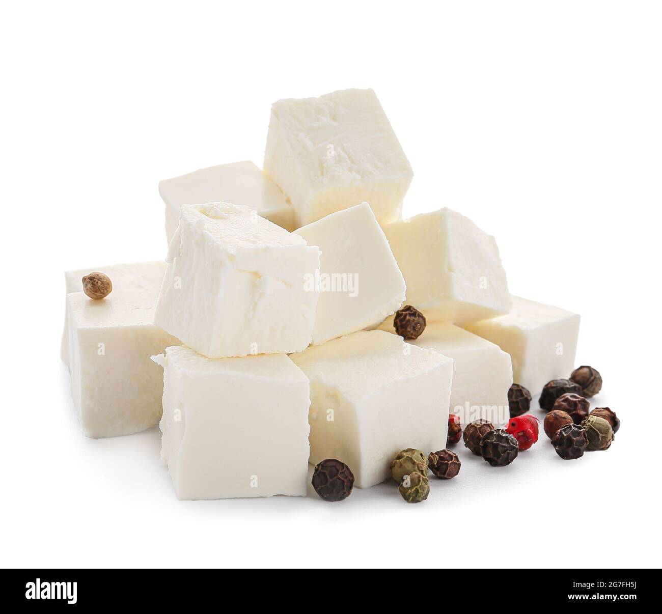 Pieces of delicious feta cheese with peppercorn on white background ...