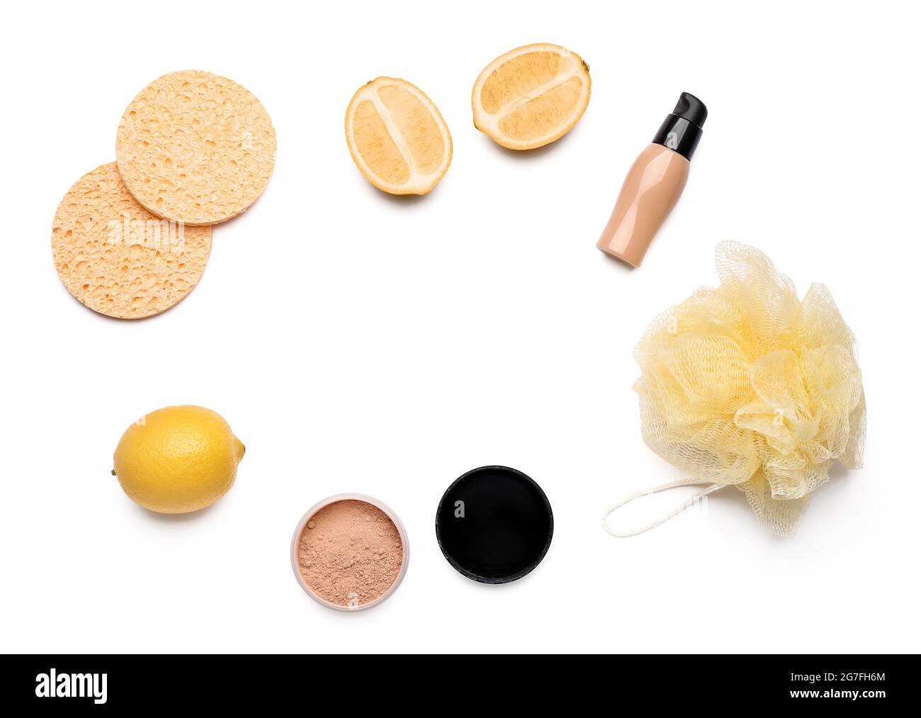 Sponges with cosmetic products, loofah and lemon on white background ...