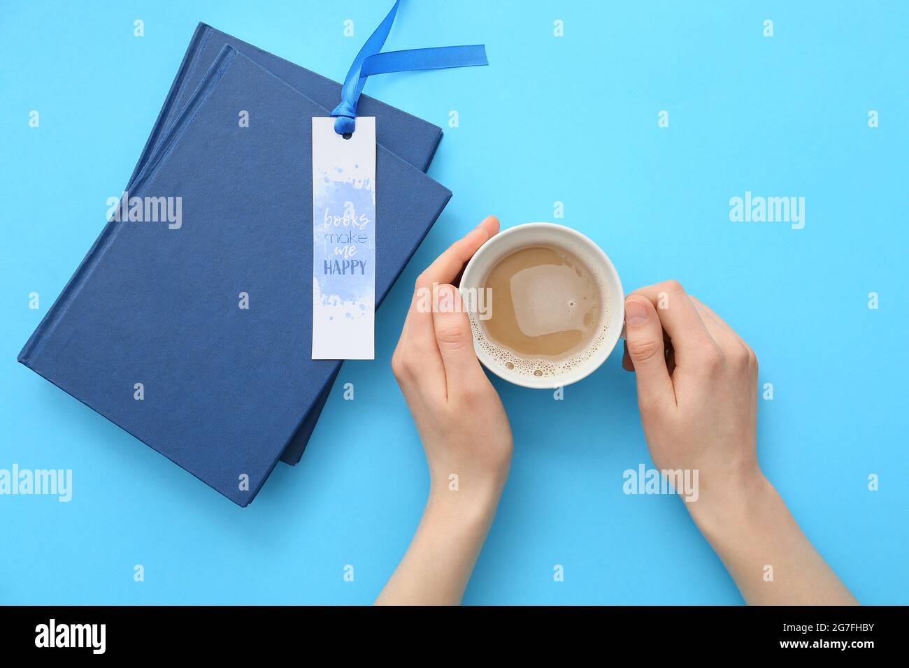 Woman with cup of coffee, bookmark and books on color background Stock ...