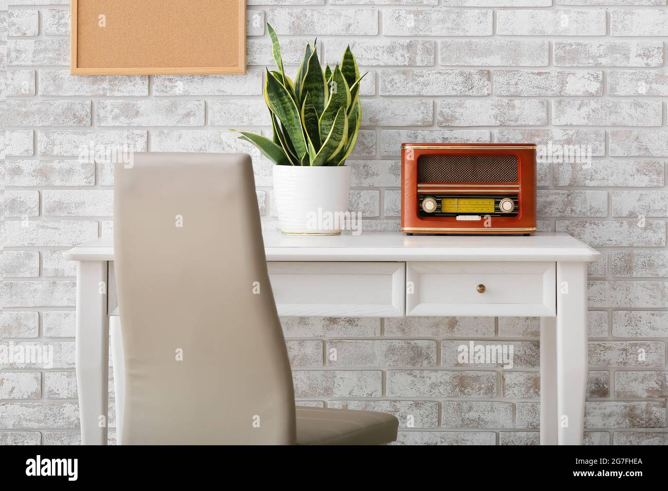 Modern workplace with retro radio receiver near brick wall Stock Photo ...