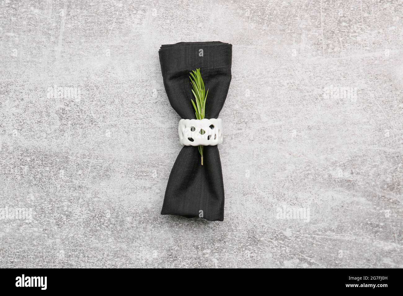 Fabric napkin with ring on grunge background Stock Photo - Alamy