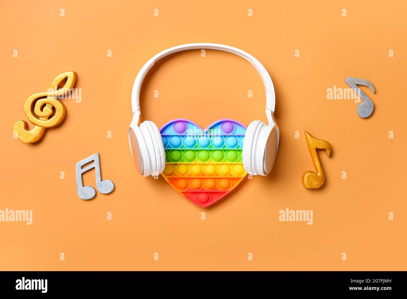 Pop it fidget toy, headphones and music notes on color background Stock ...