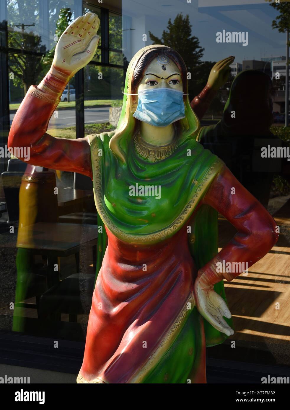 A statue of a woman, dressed in clothing from India and used as ...