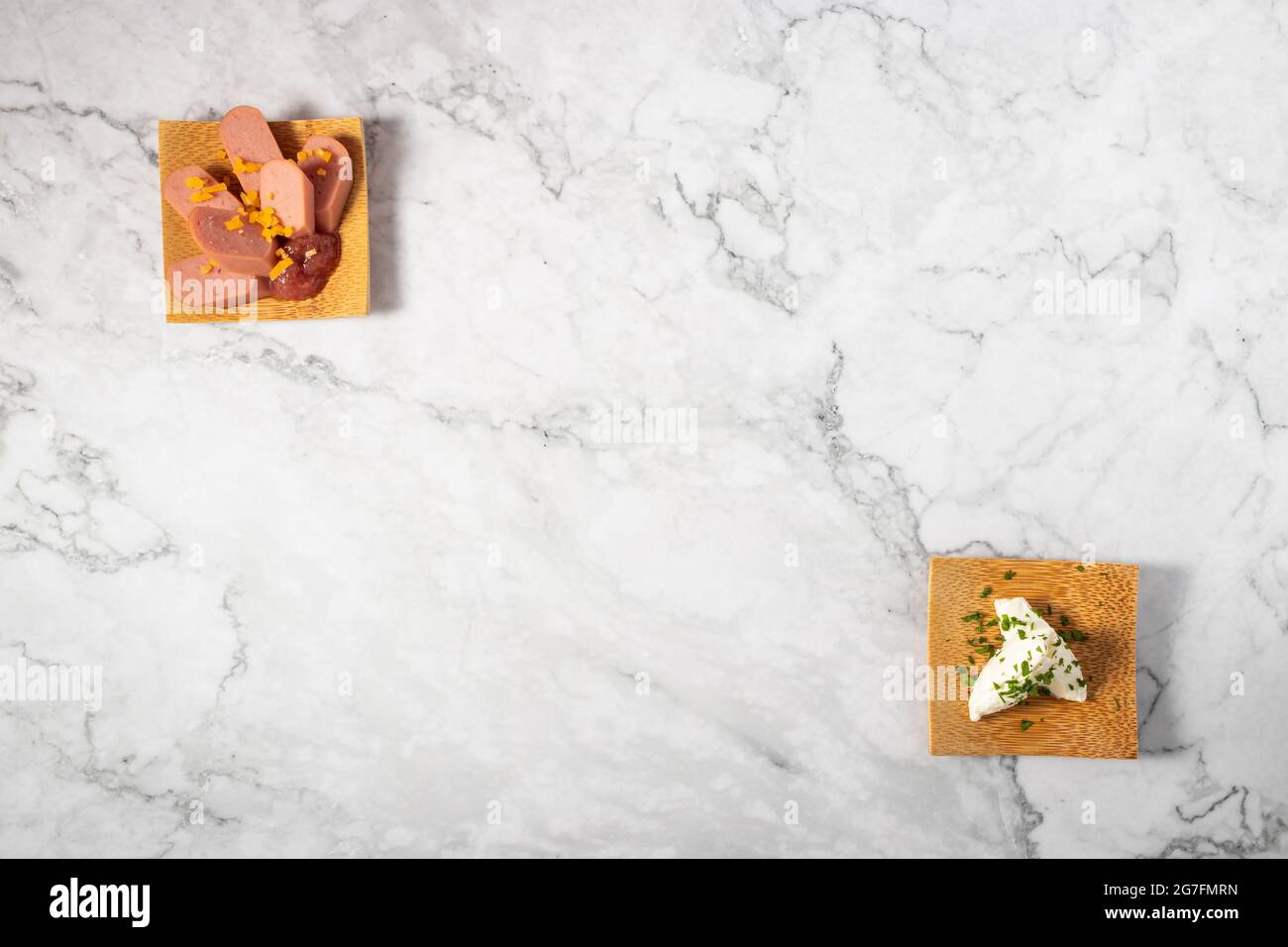 Top view of delicious appetizers on a small wooden plate on a marble ...