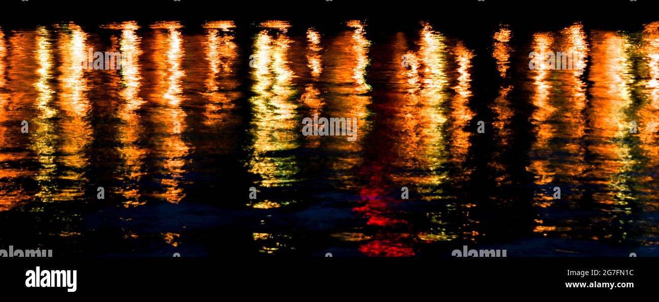 Colourful City lights reflection off the water surface Stock Photo - Alamy