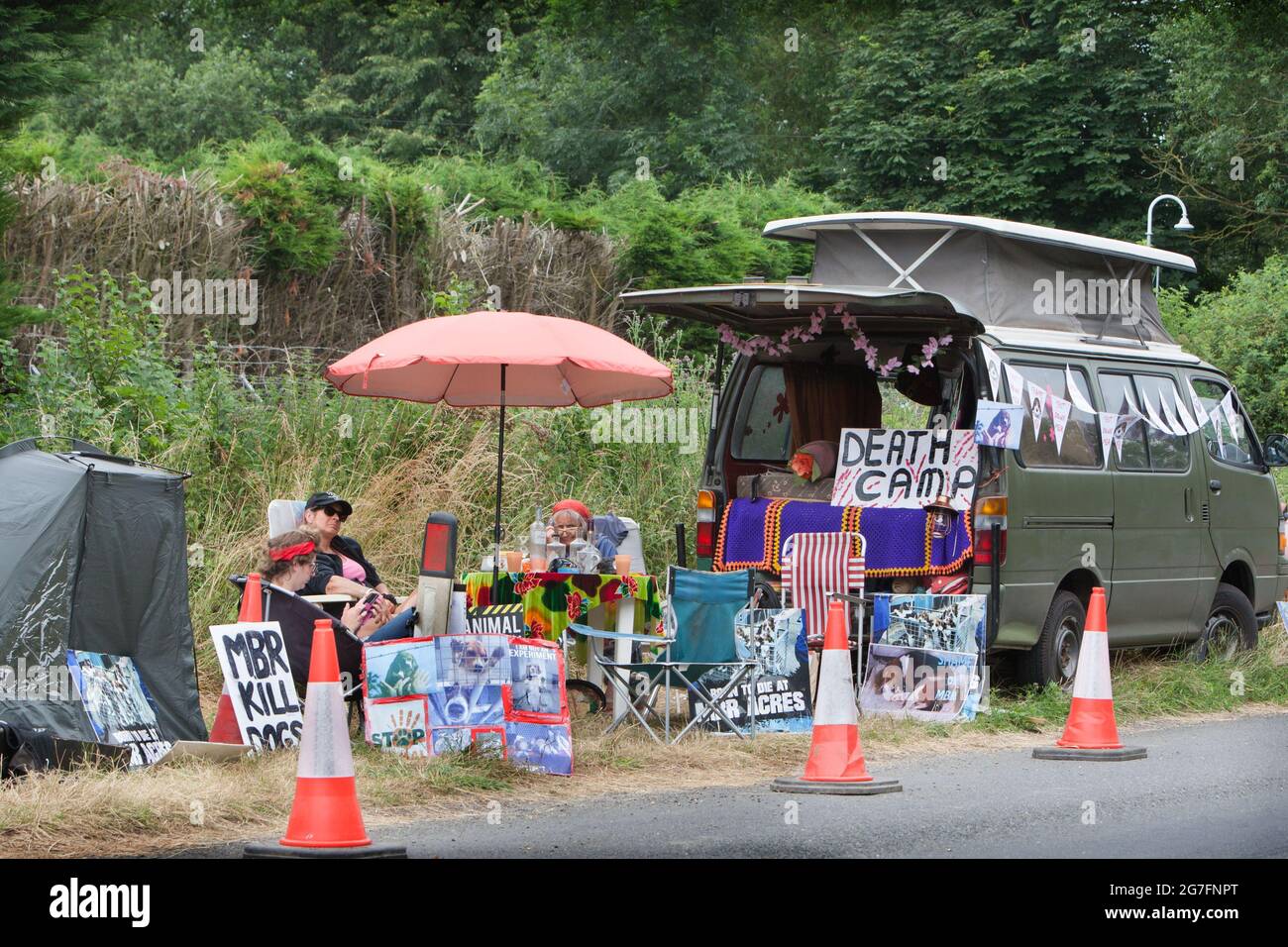 Huntingdon, UK. 13th July, 2021. Camp founder Polly sits by her camper ...