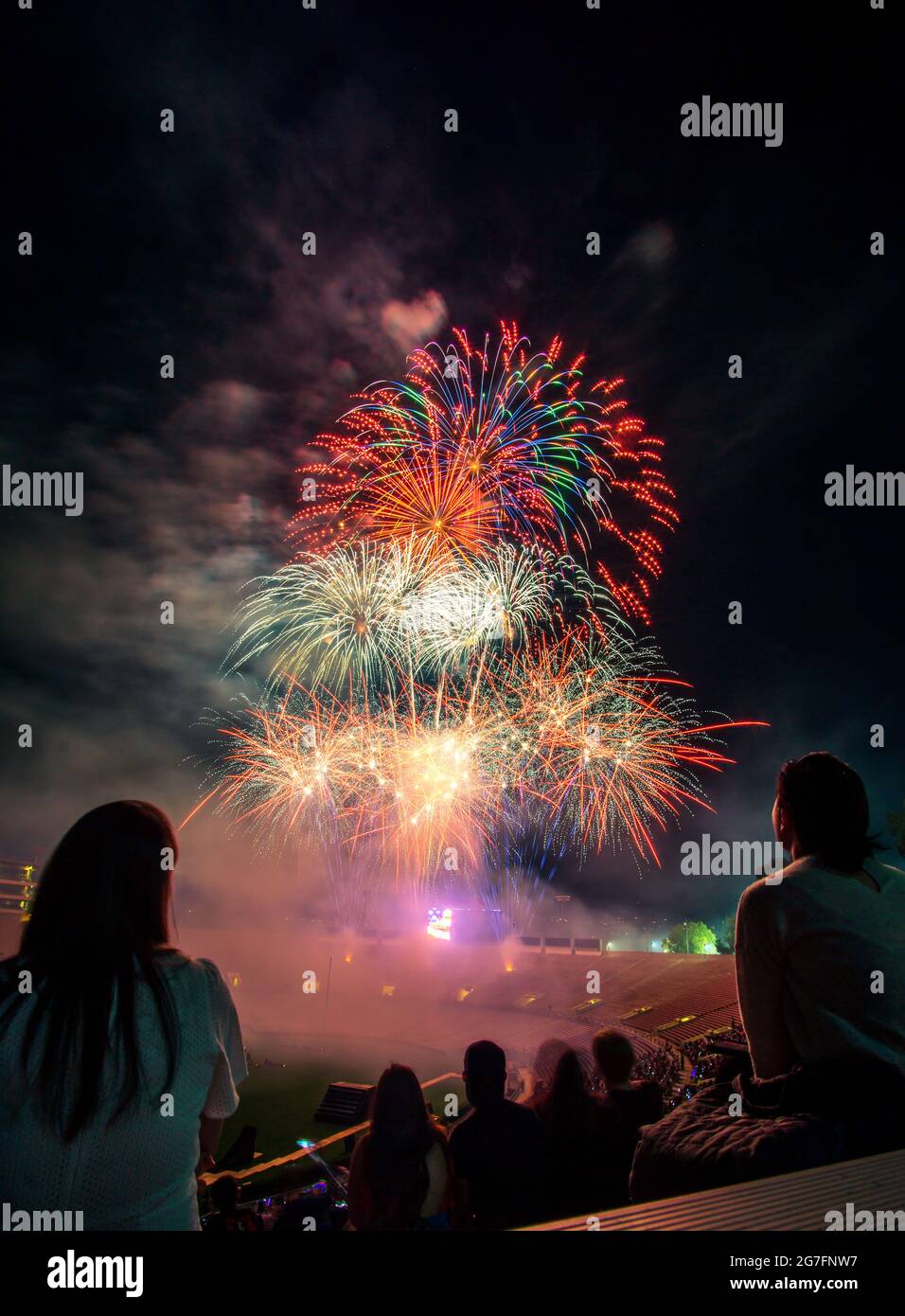Back view of a crowd in the stadium admiring the stunning colorful ...