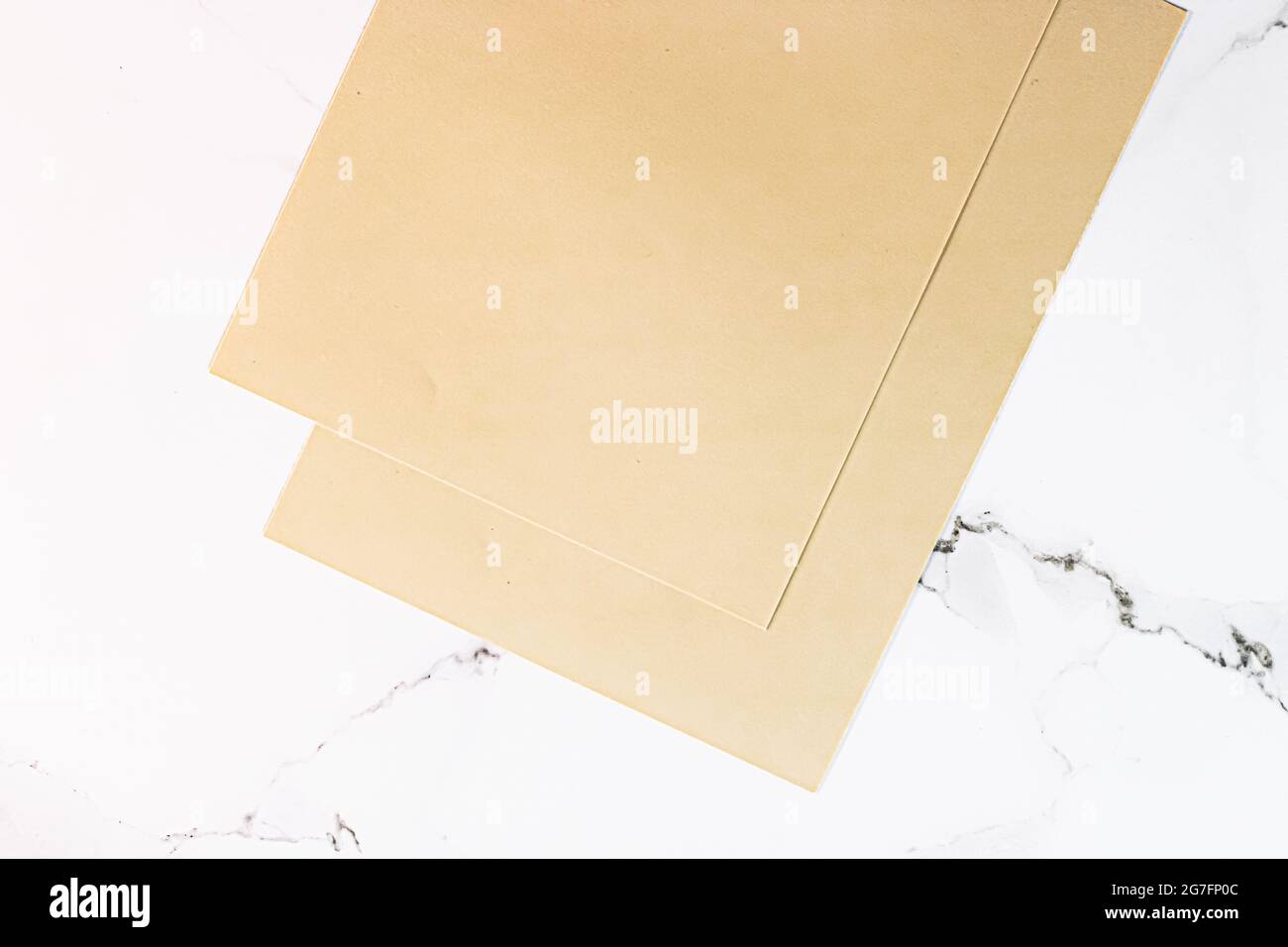Beige A4 papers on white marble background as office stationery flatlay ...
