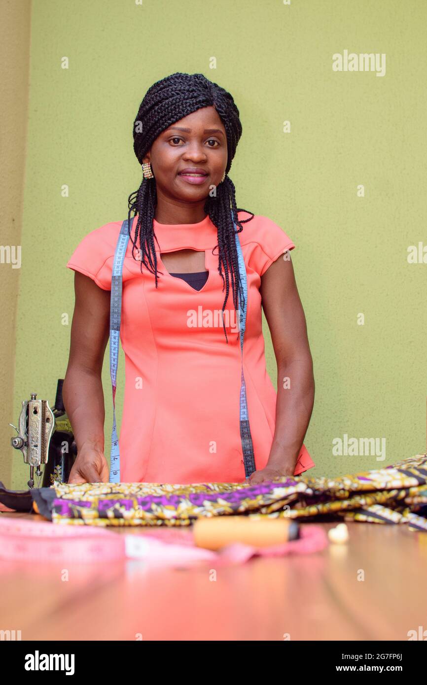 An industrious African female tailor, fashion designer or dress maker ...
