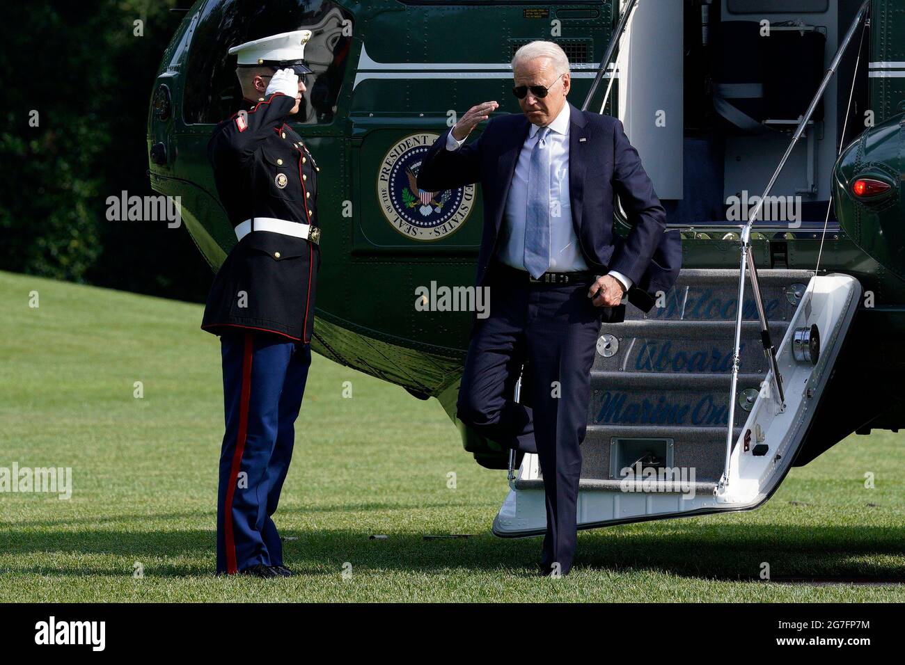 United States President Joe Biden Salutes The Marine Guard As He Steps
