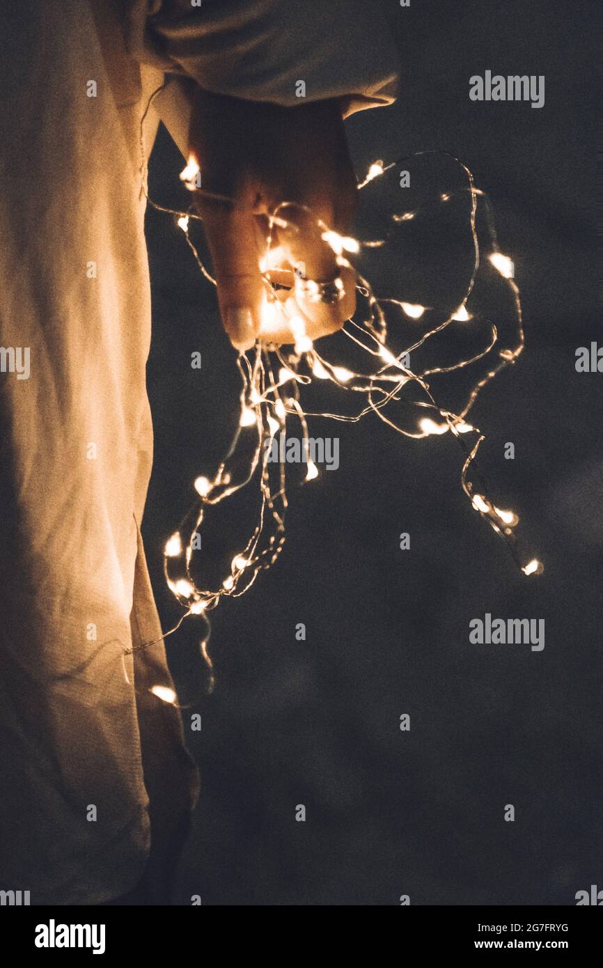 Woman's hands holding lights Stock Photo - Alamy