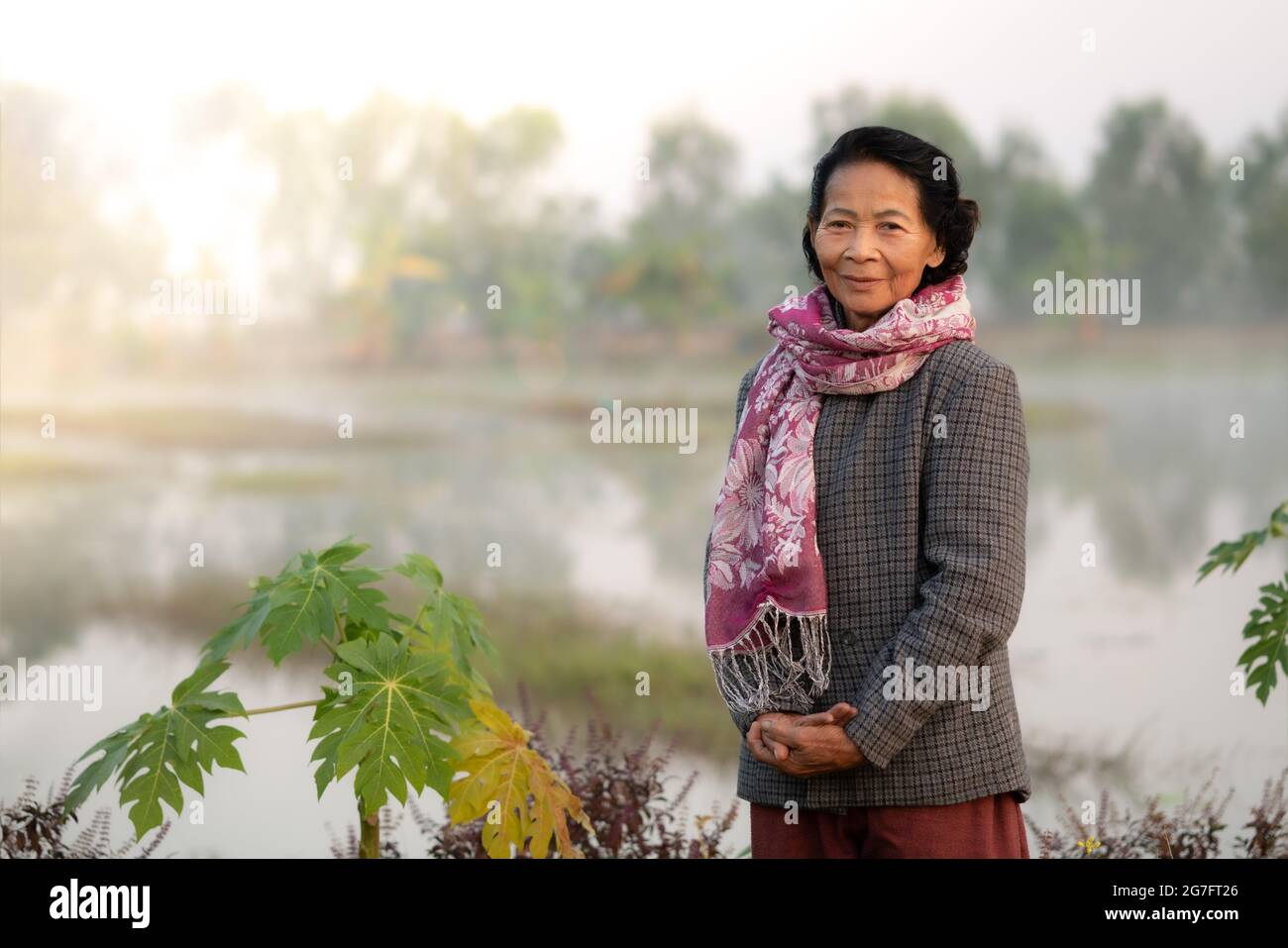Happy asian elderly senior smile with the nature farm in background ...