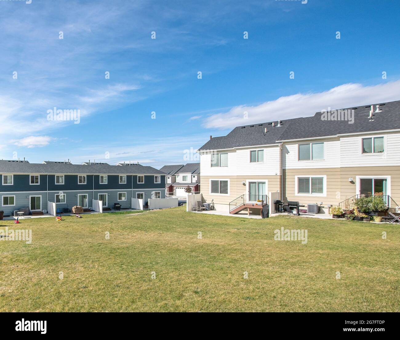 Adjacent houses in a community with large grass field Stock Photo - Alamy