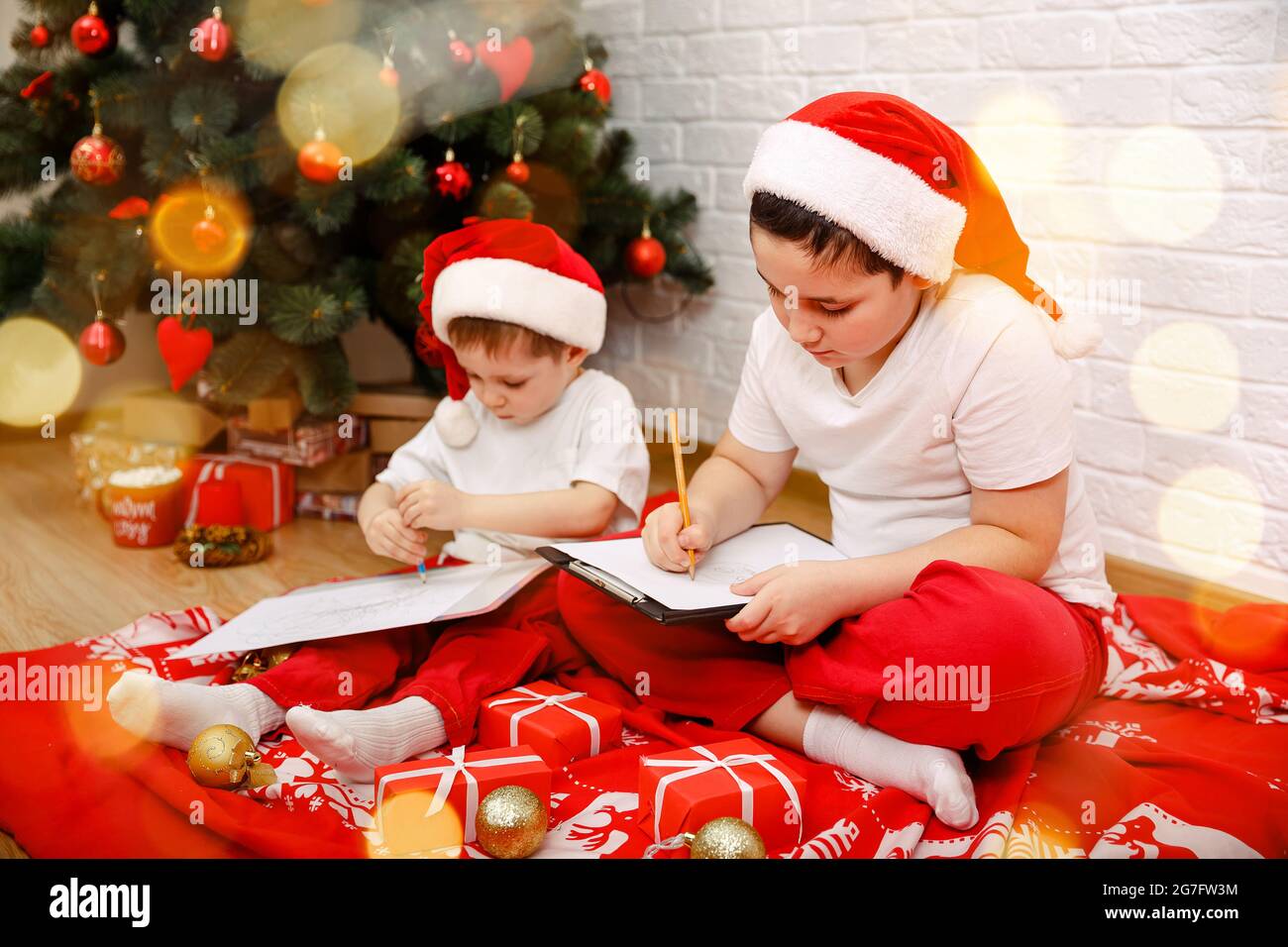 Letters for Santa Claus. Two cute little brothers writing a letter ...