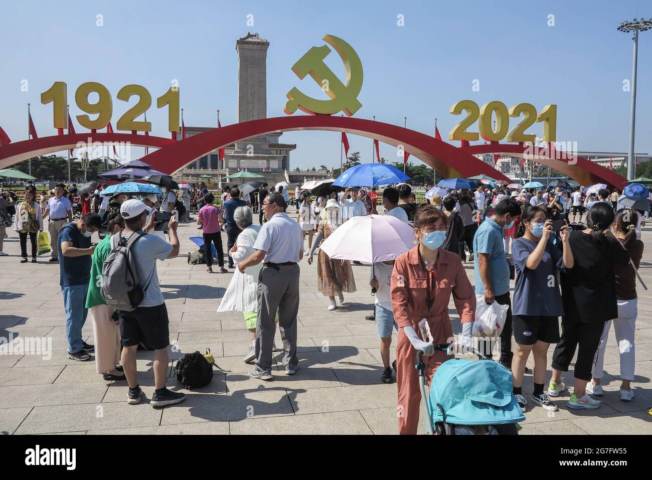 Beijing, China. 09th July, 2021. Tourists walk under the Communist ...