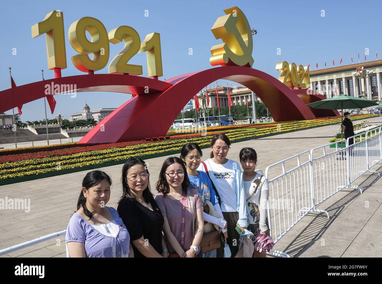 Beijing, China. 9th July, 2021. A group of tourists take photos under ...