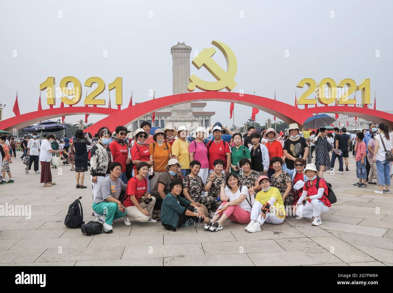 Beijing, China. 11th July, 2021. A group of tourists take photos under ...