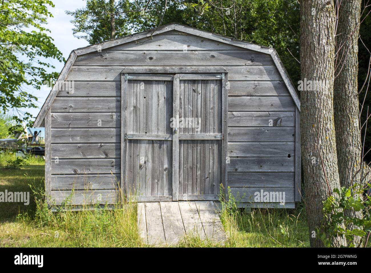 Wooden barn entrance and a platform in the greenery Stock Photo - Alamy