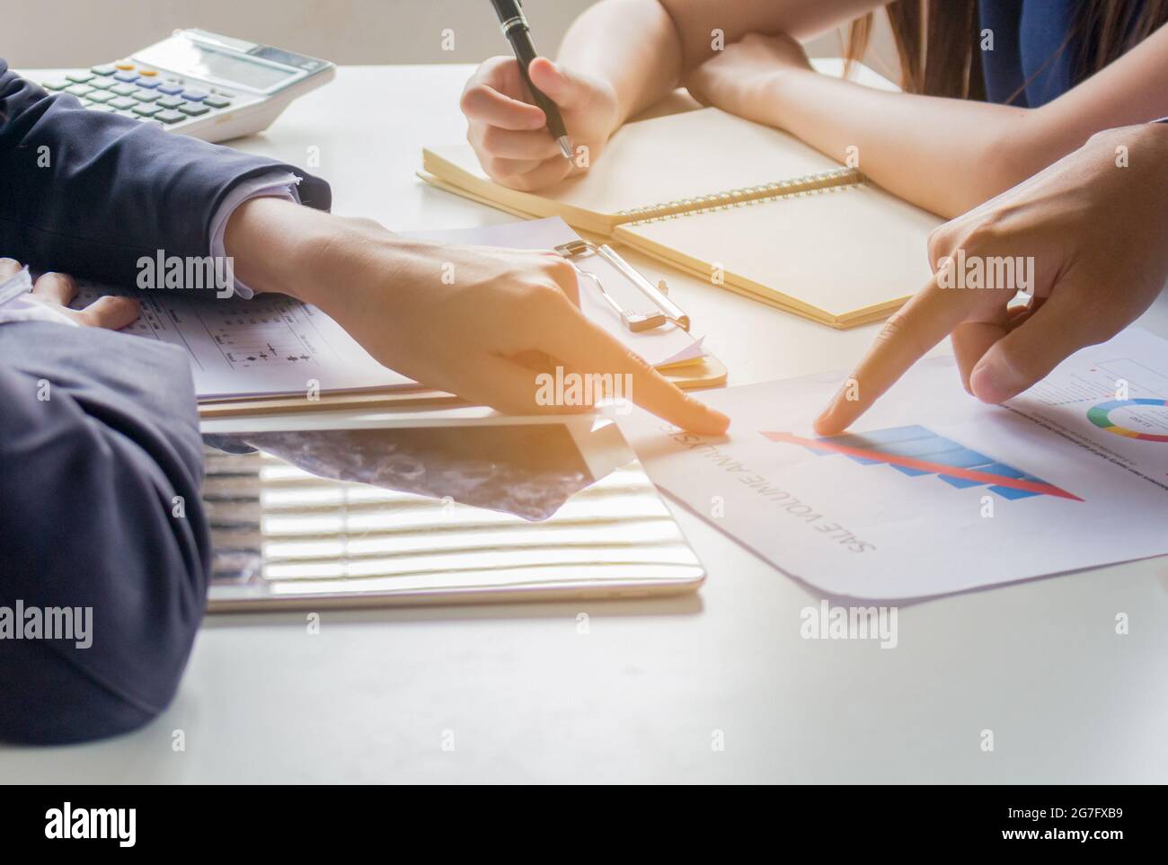 group of business people are meeting and watching graphs for business ...