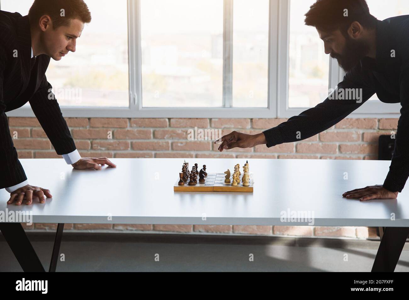 two male businessmen, rivals are playing chess. Strategy and rivalry ...