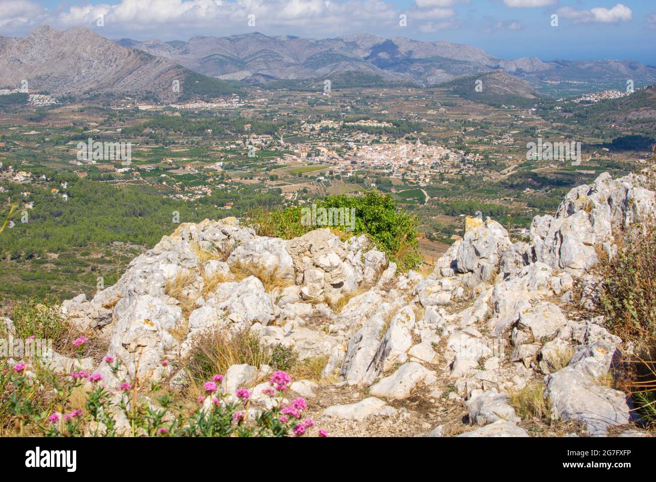Small town of Parcent in distant flat plains between mountains from ...