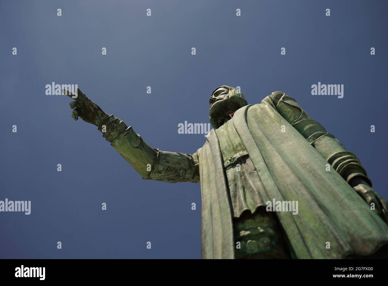Low angle shot of a statue of a man pointing forward - sky background ...