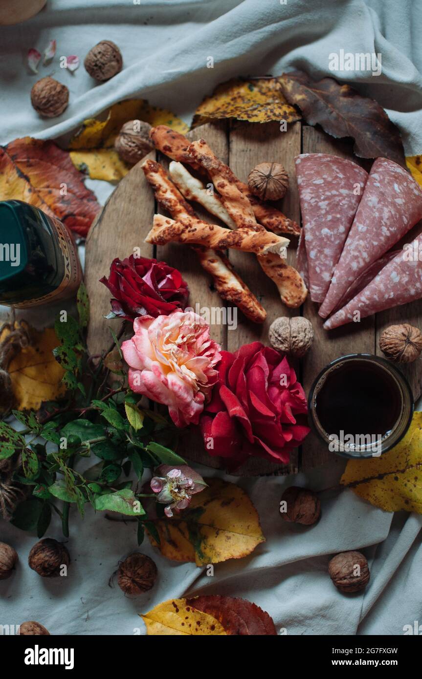 Top view of an appetizing platter of meat and bread sticks decorated ...