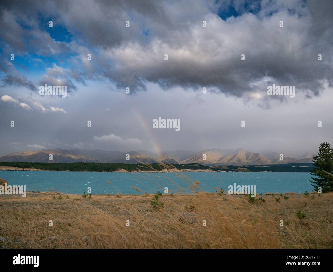 Scenic cloudscape with a rainbow over the lake Stock Photo - Alamy