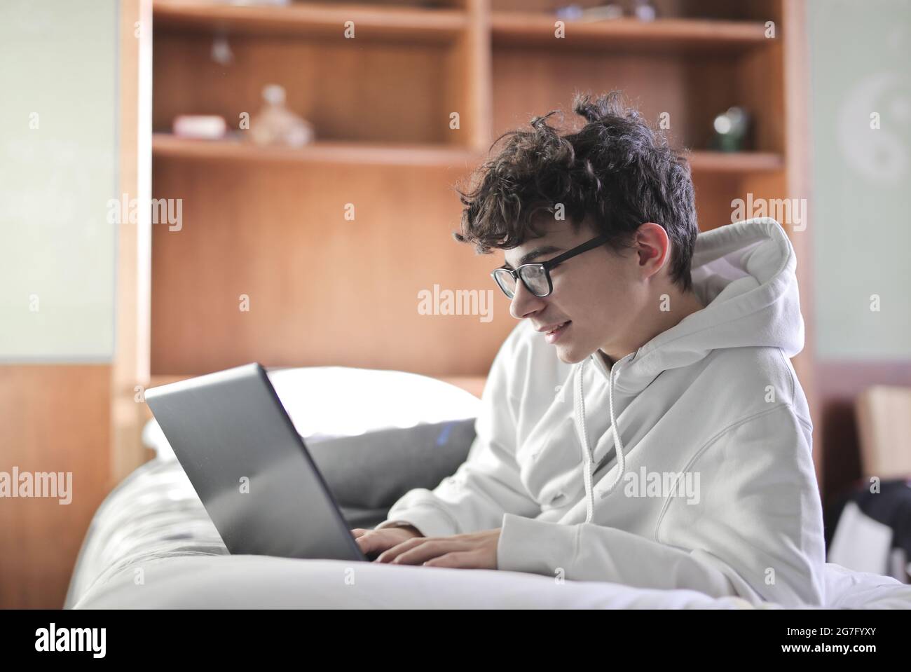 Teen boy glasses working on hi-res stock photography and images - Alamy