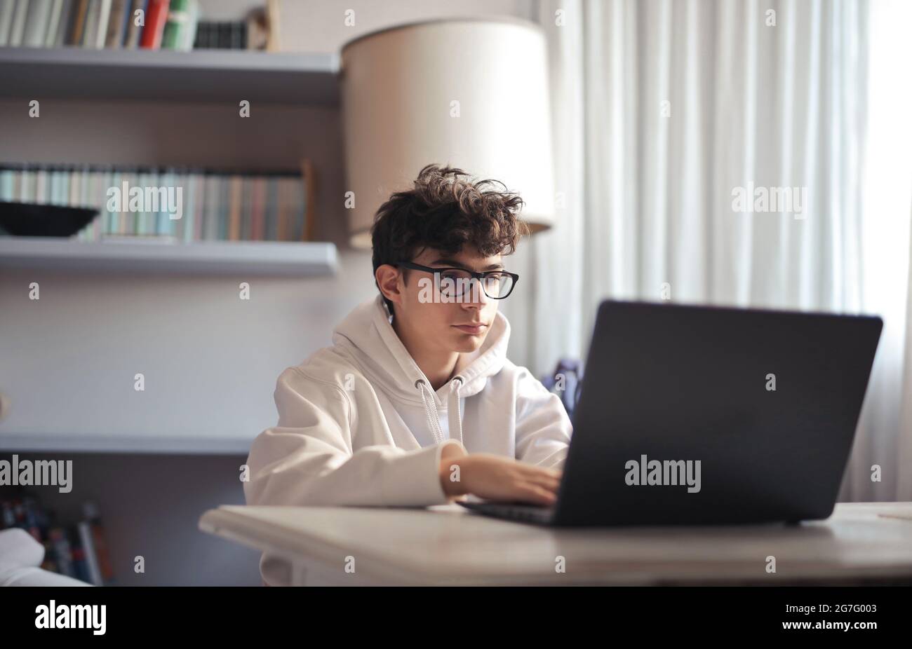 Teen boy glasses working on hi-res stock photography and images - Alamy