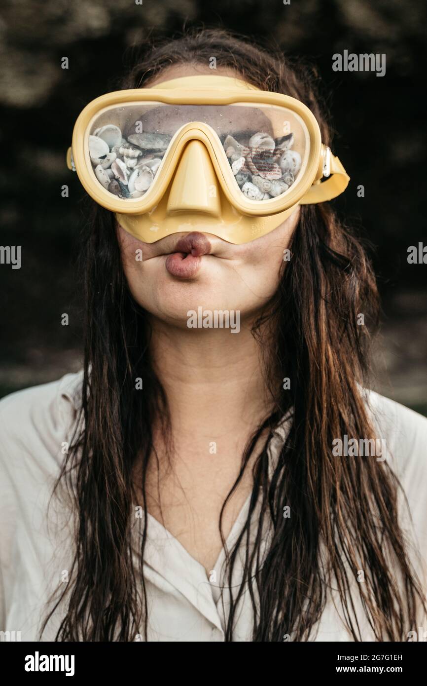 Portrait of a girl wearing snorkeling mask filled with seashells Stock ...