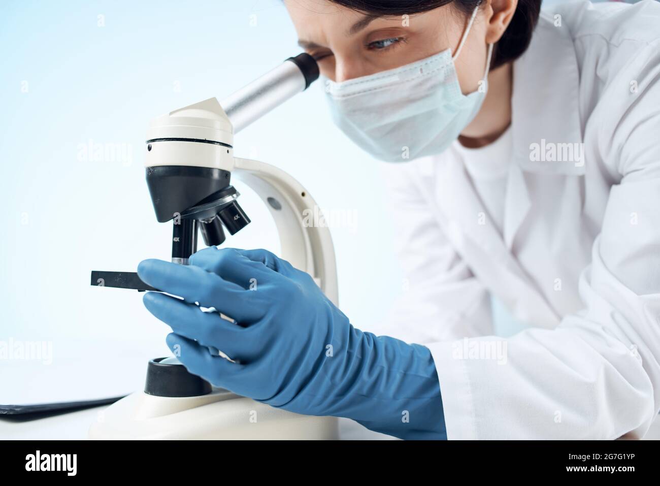 woman wearing medical mask microscope laboratory technology ...