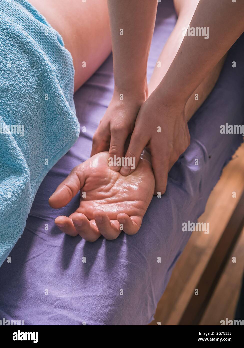 two people, physiotherapist massaging man's hand muscles Stock Photo ...