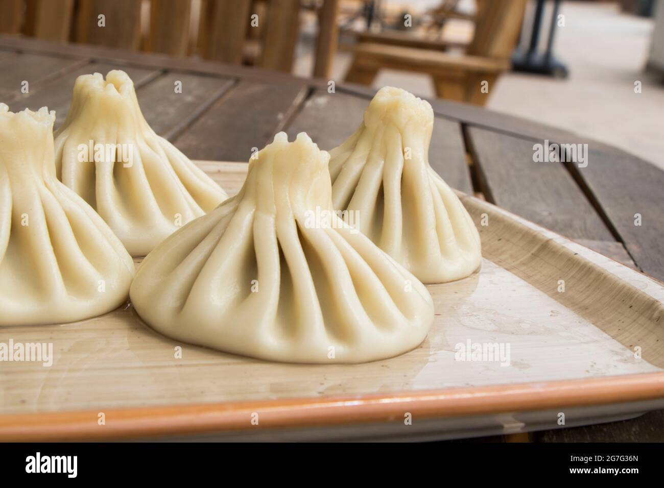 Georgian traditional food khinkali on the plate in restaurant, ready to ...